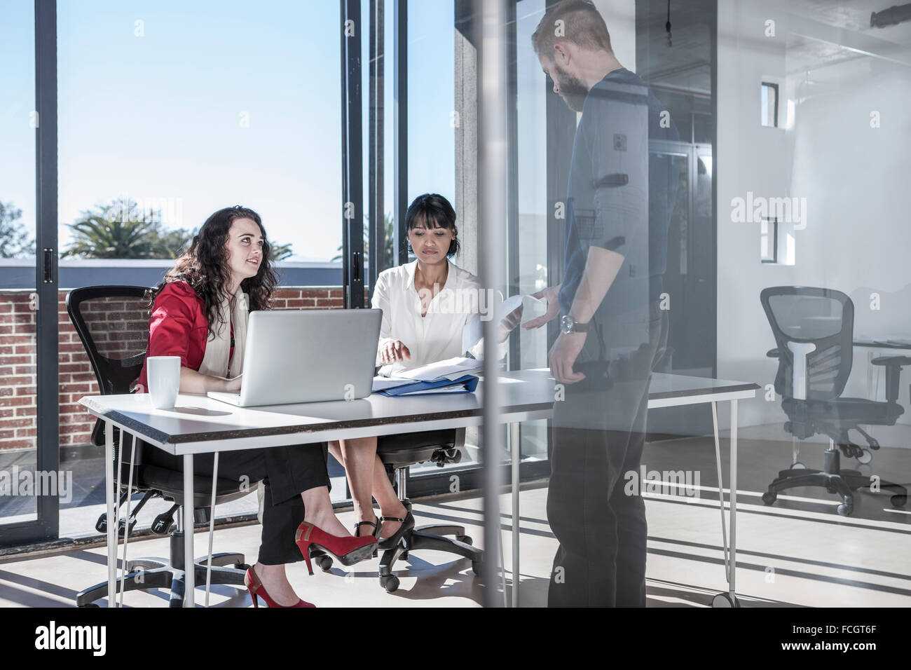 Young professionals working together in office Stock Photo - Alamy