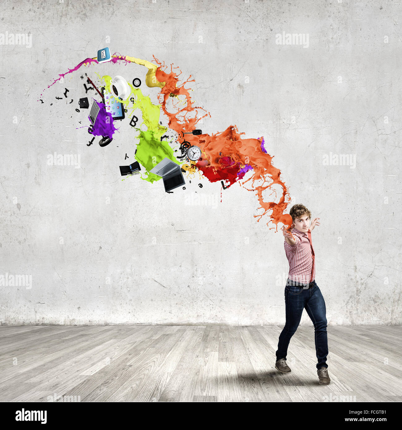 Young man in casual throwing colorful paint splashes Stock Photo - Alamy