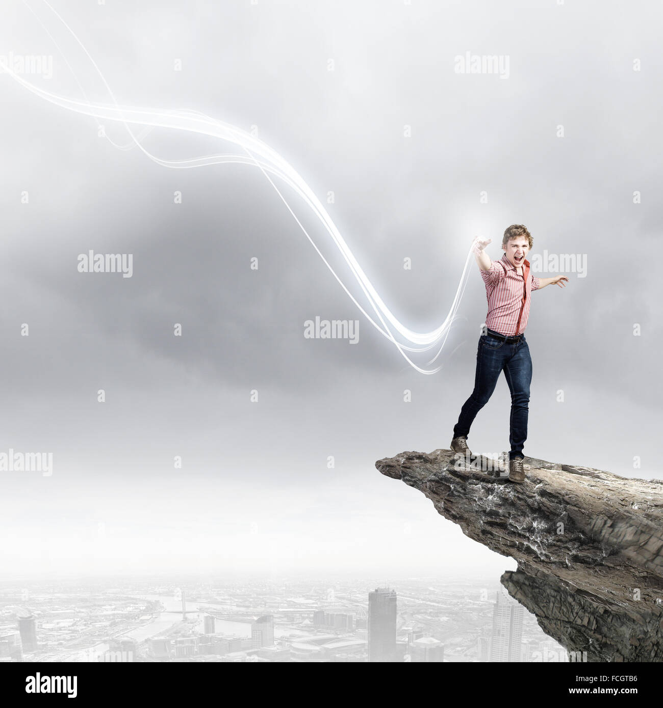 Young man in casual throwing light splashes Stock Photo - Alamy