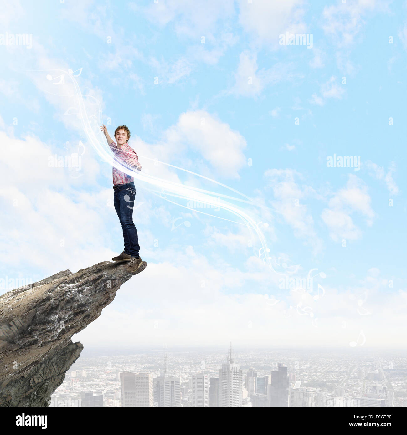 Young man in casual throwing light splashes Stock Photo - Alamy