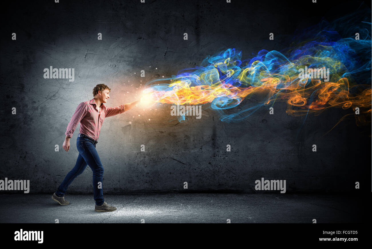 Young man in casual throwing colorful paint splashes Stock Photo - Alamy