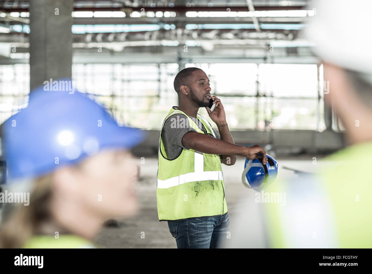 Construction worker on cell phone in construction site Stock Photo - Alamy