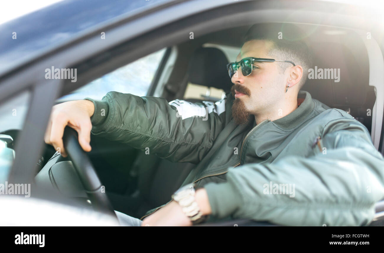 Young man driving a car Stock Photo - Alamy