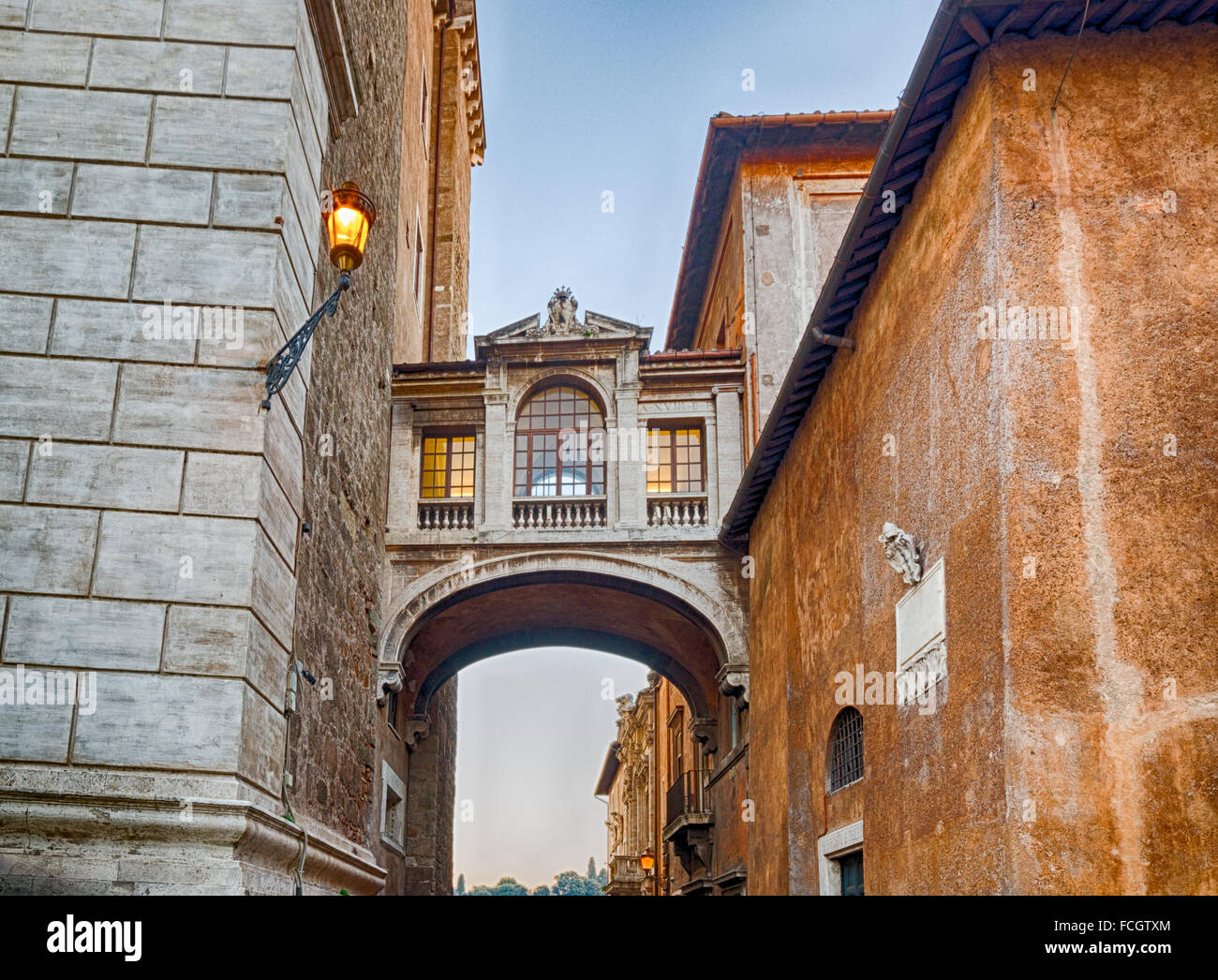 romantic road with bridge joining two old buildings in Rome, Italy ...