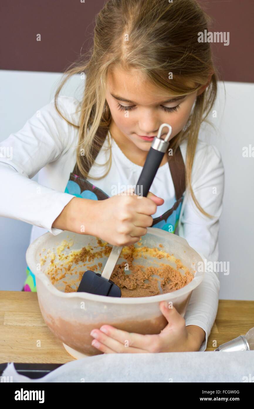 Little girl stirring dough Stock Photo - Alamy