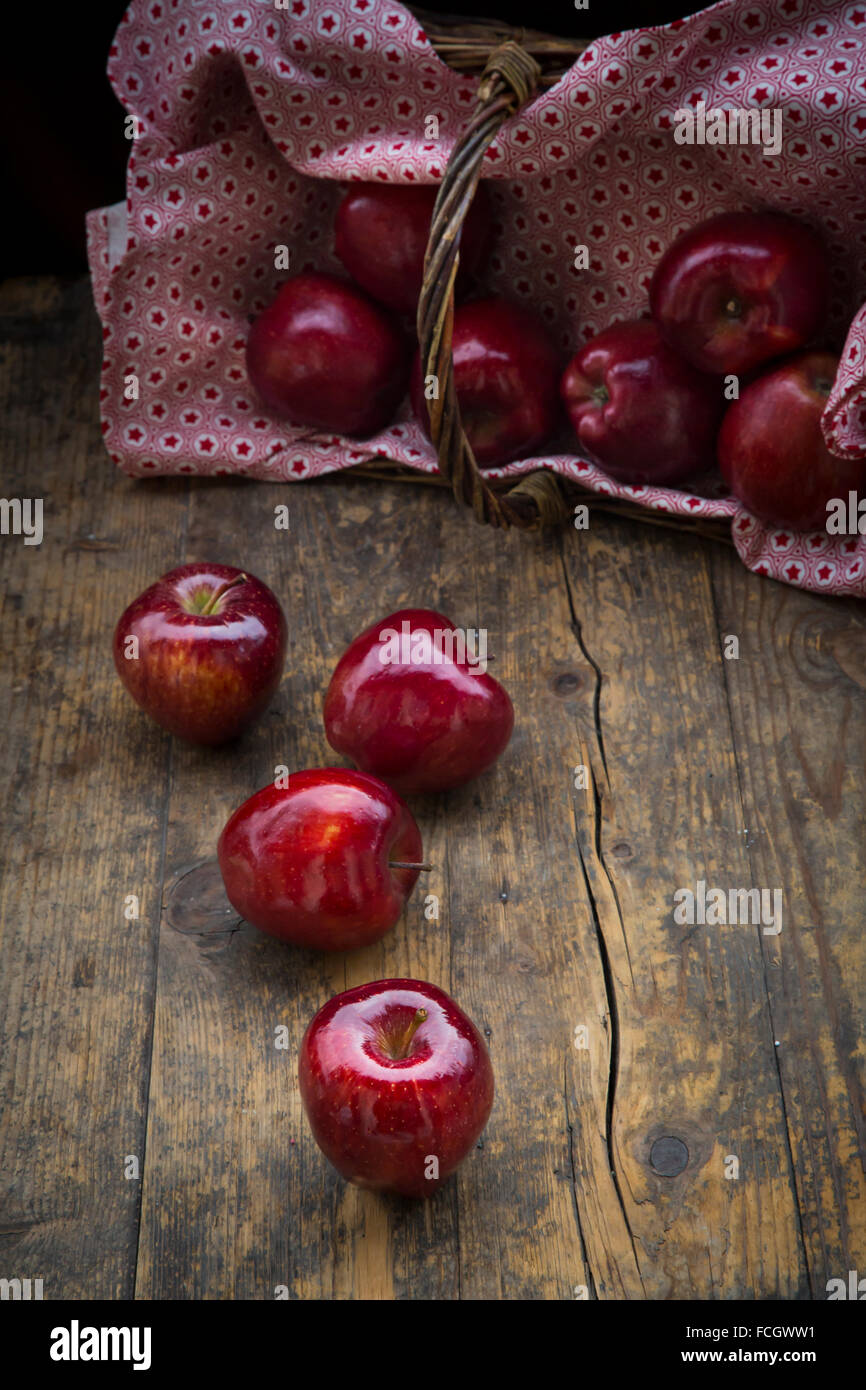 Four red apples on dark wood Stock Photo - Alamy
