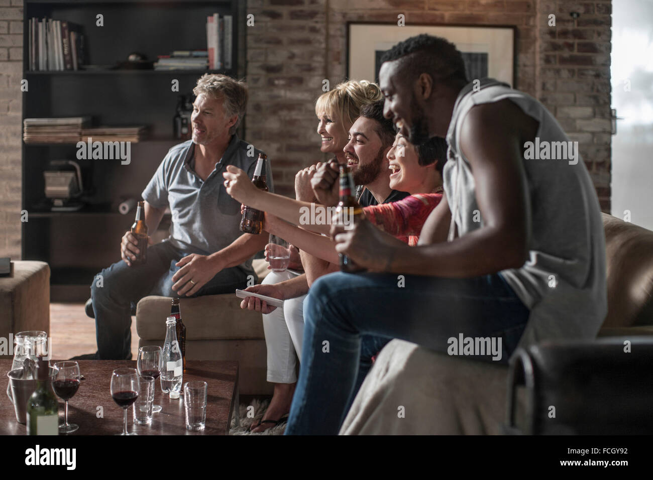 Friends together having a good time watching TV Stock Photo - Alamy