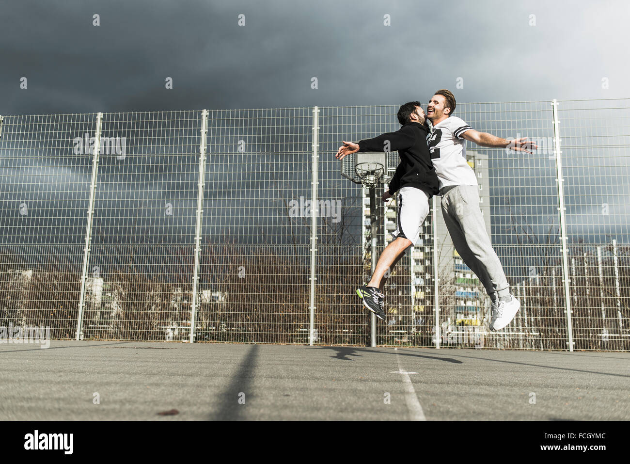 Two young basketball players jumping Stock Photo - Alamy
