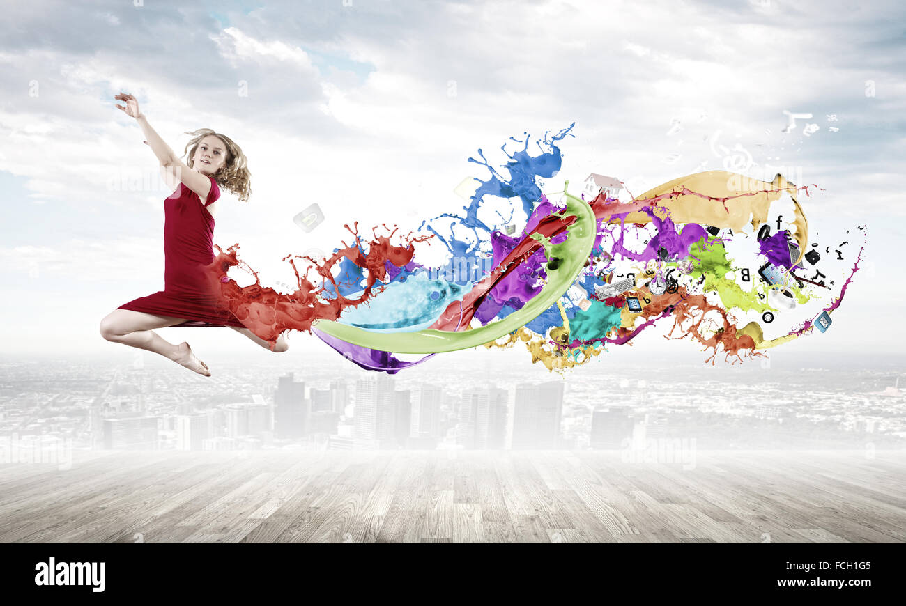 Young woman dancer in red dress jumping high Stock Photo - Alamy