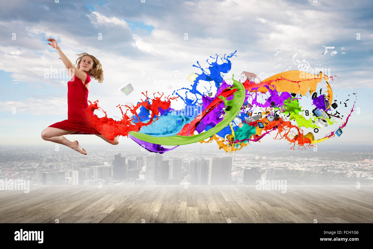 Young woman dancer in red dress jumping high Stock Photo - Alamy