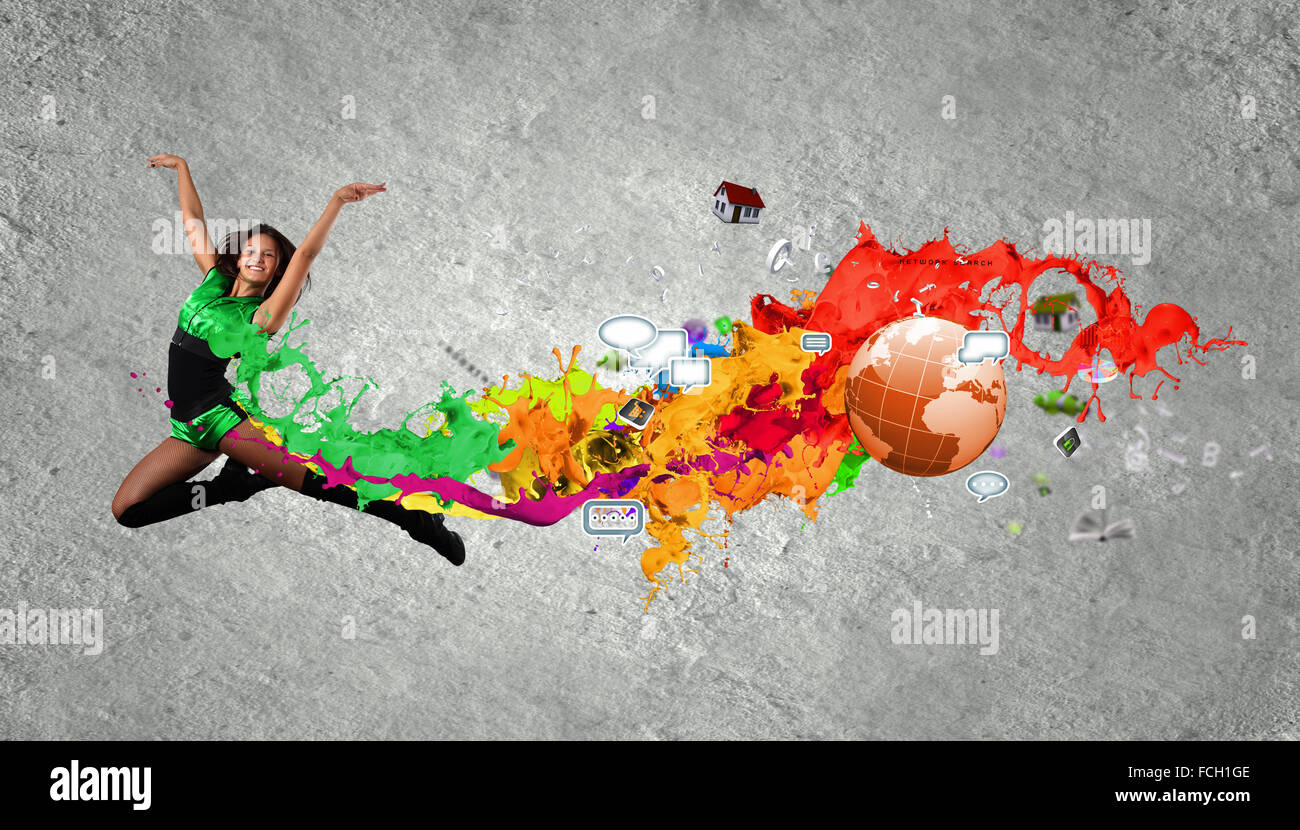 Young woman dancer in green suit jumping high Stock Photo - Alamy