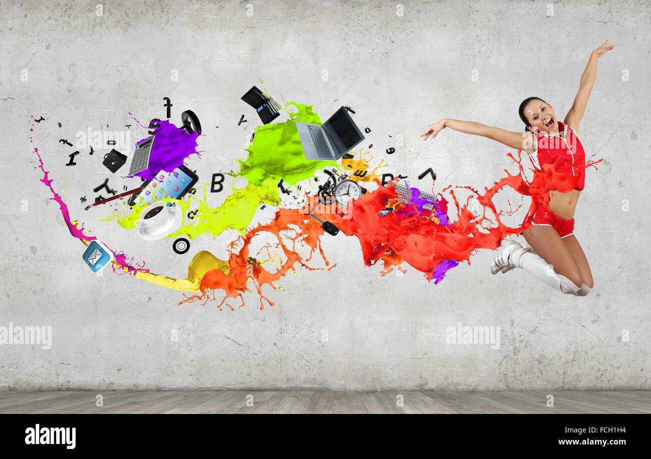 Young woman dancer in red suit jumping high Stock Photo - Alamy