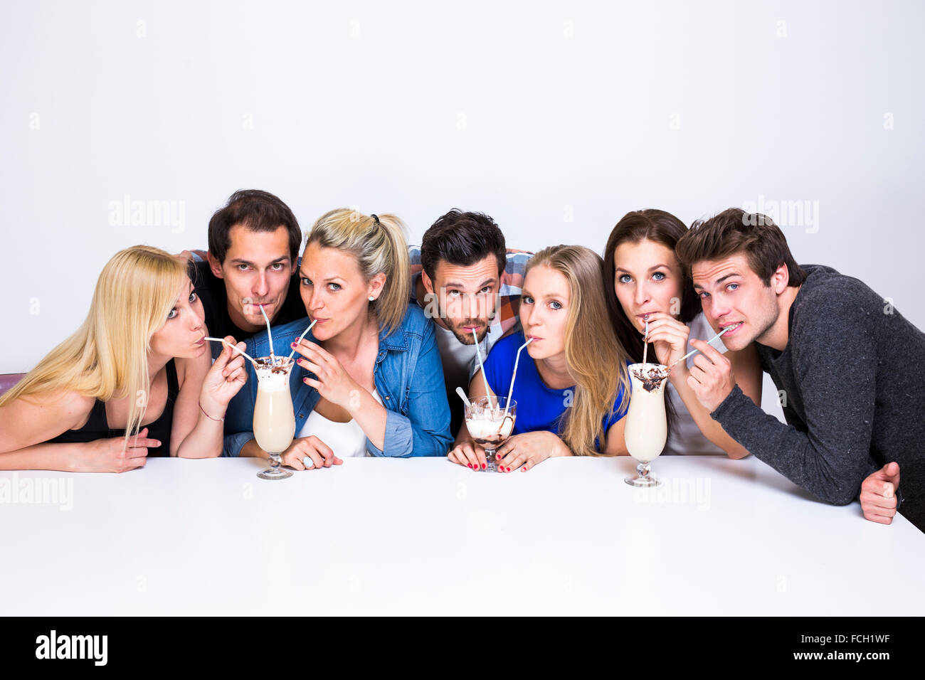 Group of friends drinking milkshakes Stock Photo - Alamy