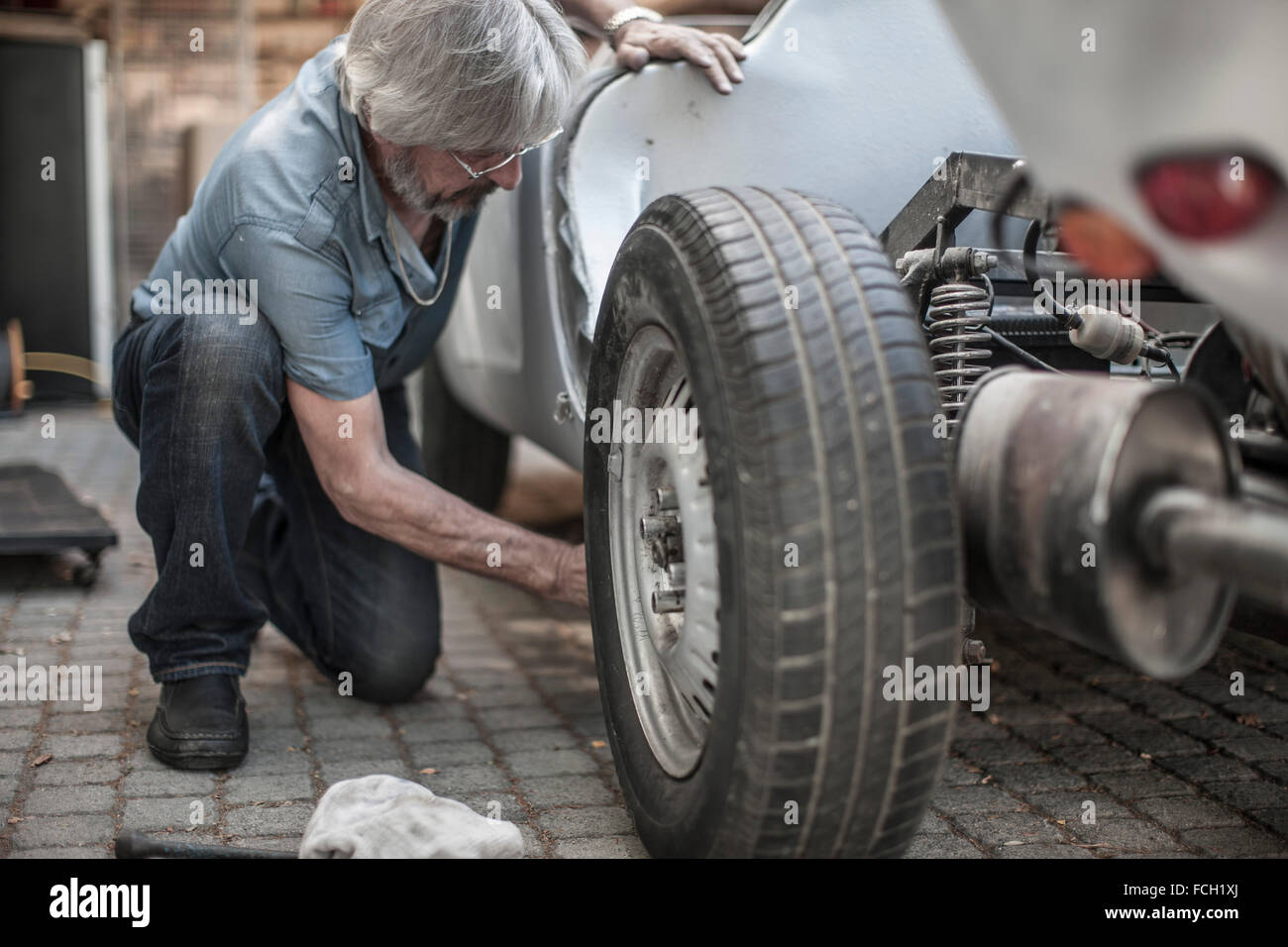 Senior man restoring a car Stock Photo - Alamy