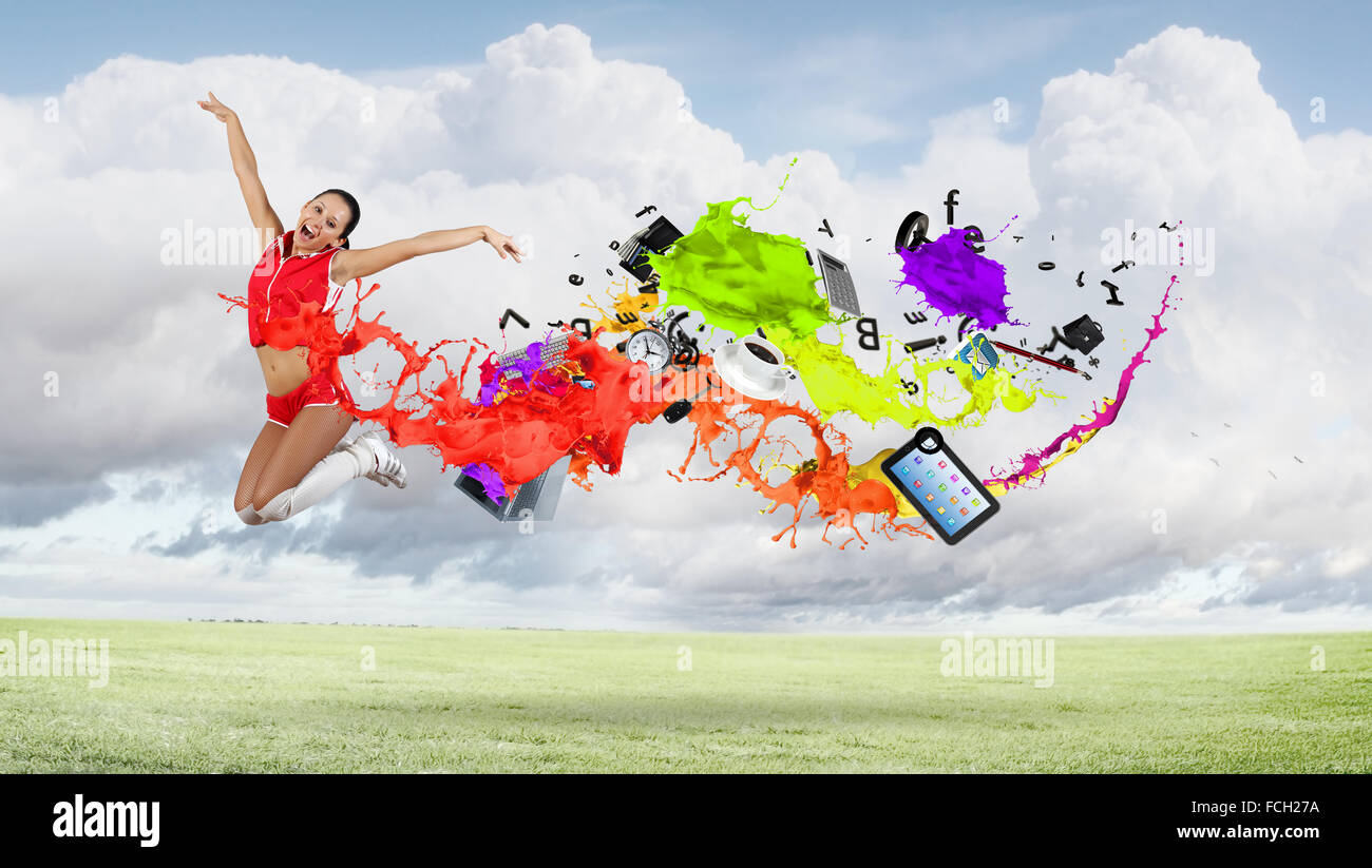 Young woman dancer in red suit jumping high Stock Photo - Alamy