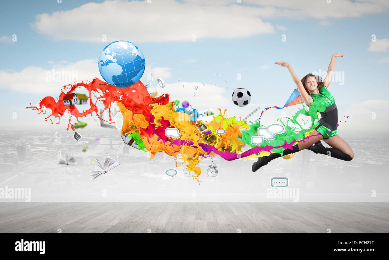 Young woman dancer in green suit jumping high Stock Photo - Alamy