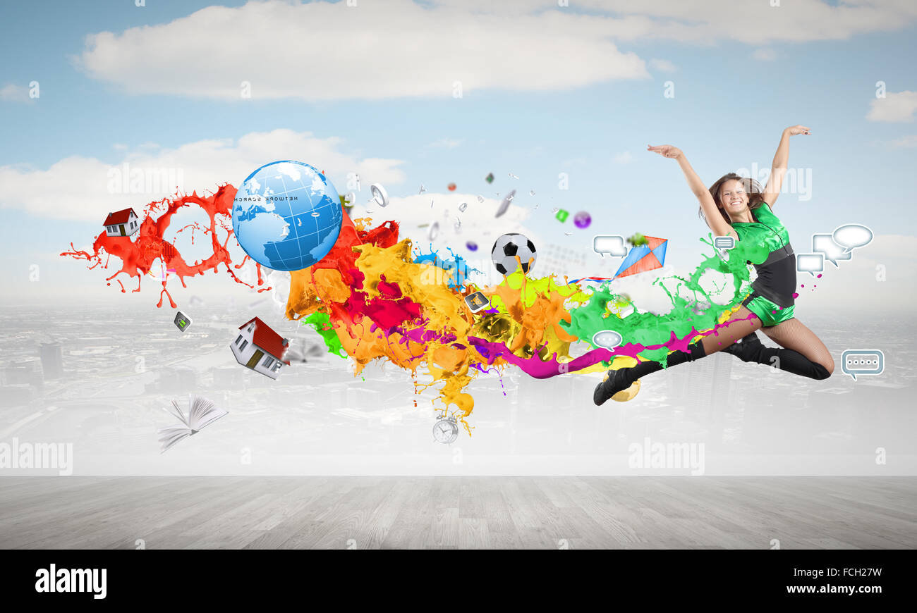 Young woman dancer in green suit jumping high Stock Photo - Alamy