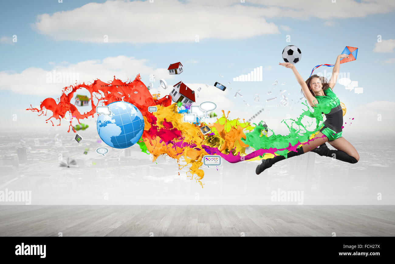 Young woman dancer in green suit jumping high Stock Photo - Alamy