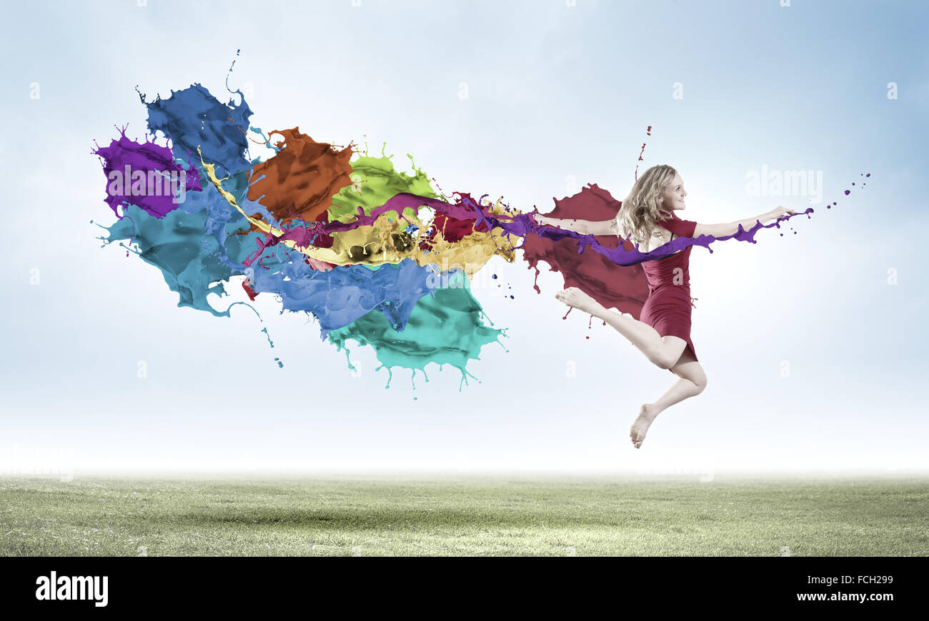 Young woman dancer in red dress jumping high Stock Photo - Alamy
