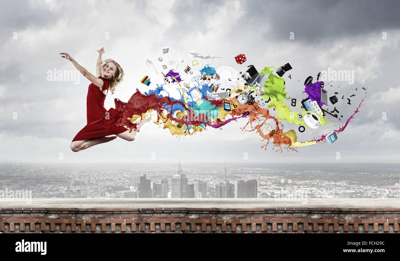 Young woman dancer in red dress jumping high Stock Photo - Alamy