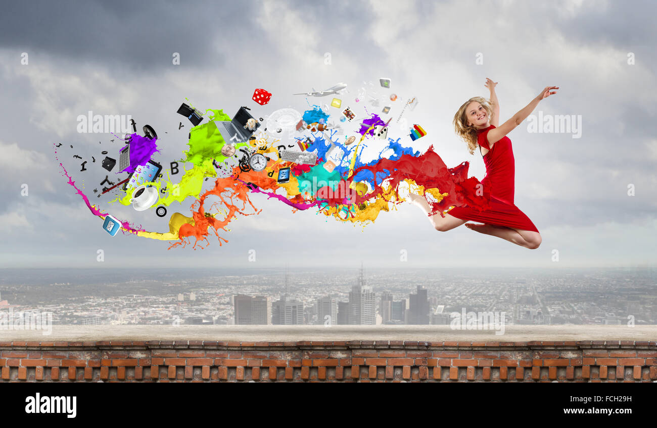 Young woman dancer in red dress jumping high Stock Photo - Alamy