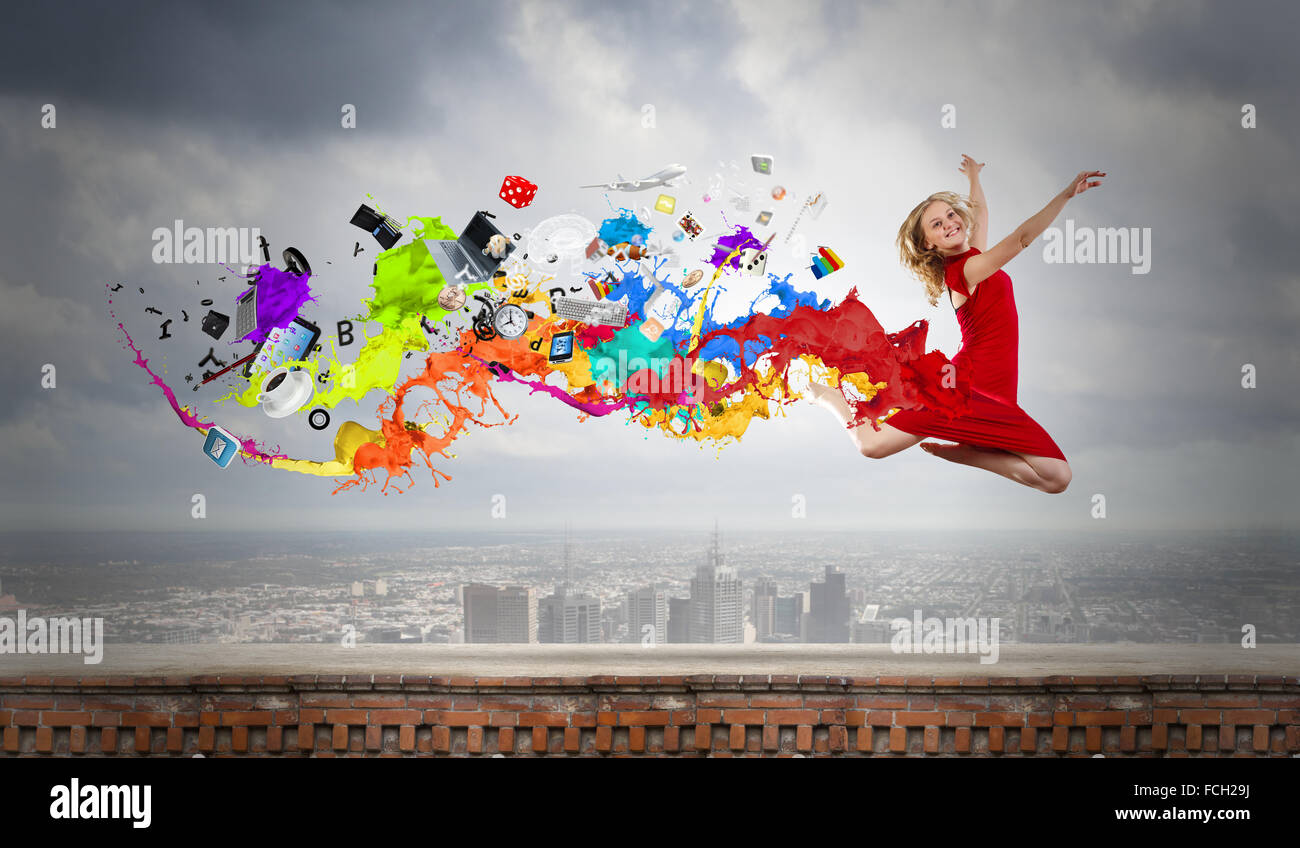 Young woman dancer in red dress jumping high Stock Photo - Alamy