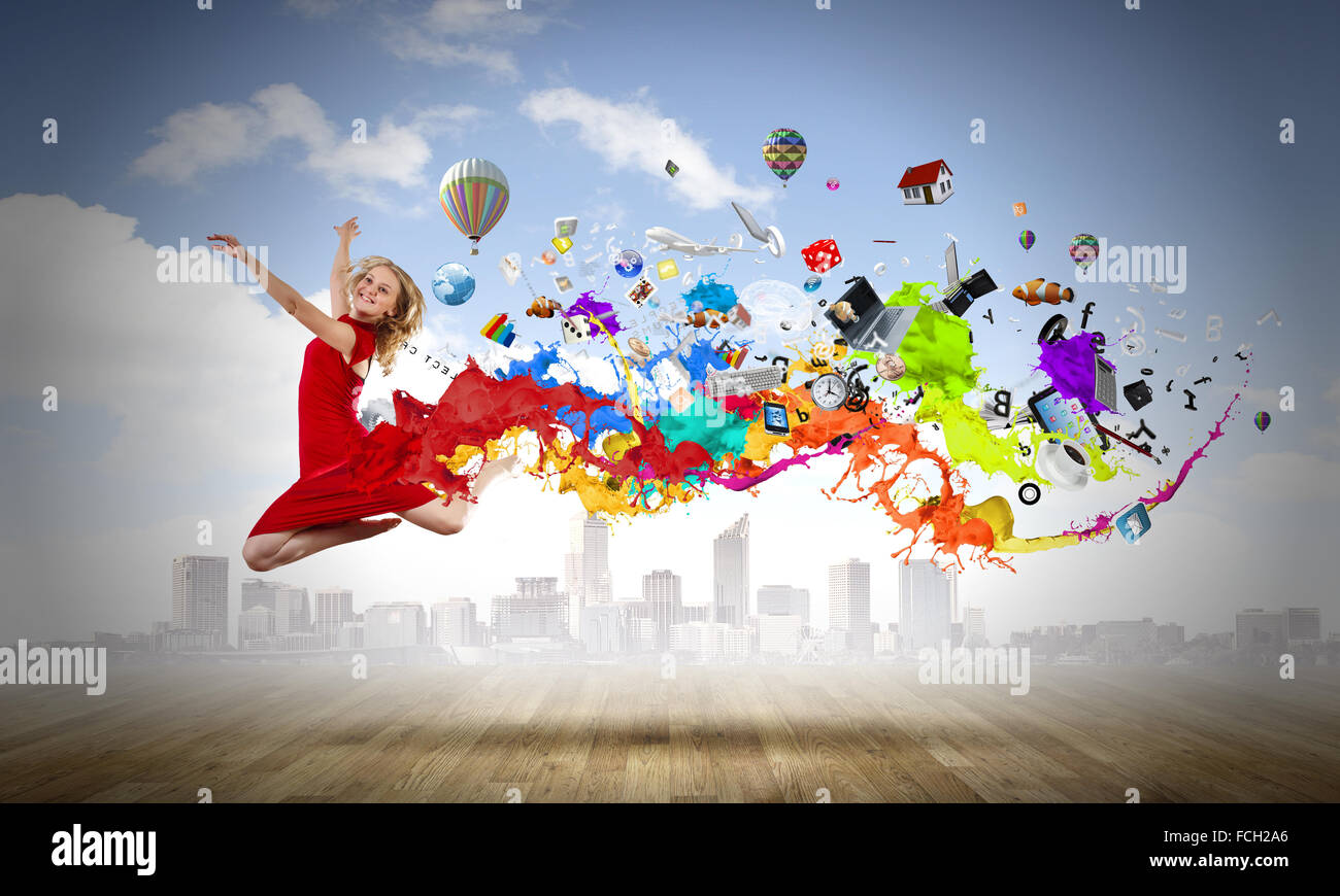 Young woman dancer in red dress jumping high Stock Photo - Alamy
