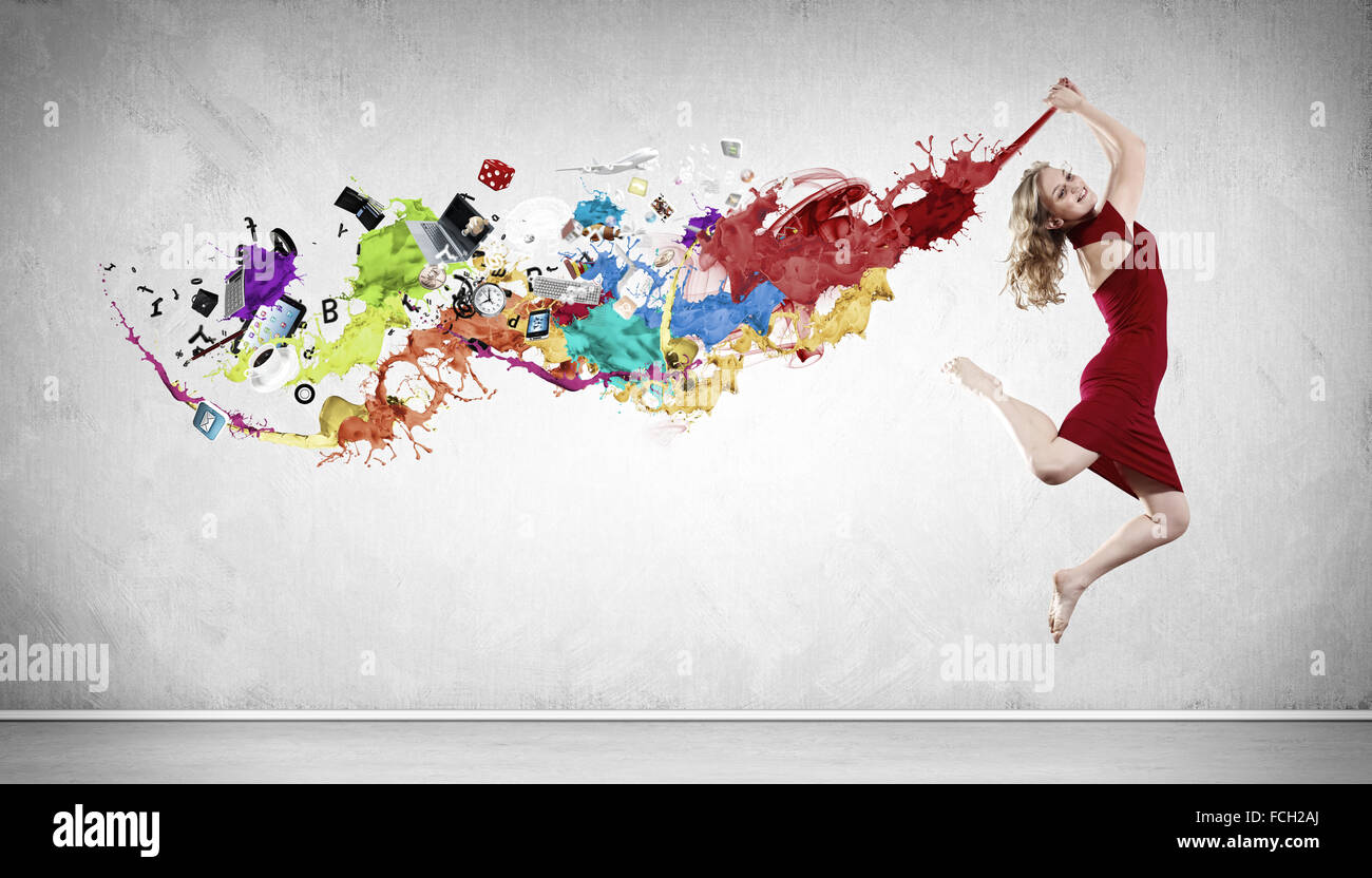 Young woman dancer in red dress jumping high Stock Photo - Alamy