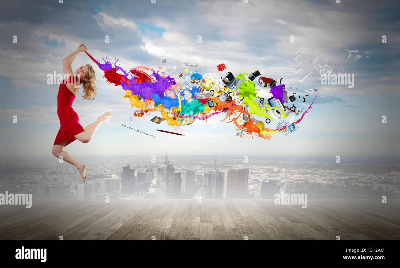 Young woman dancer in red dress jumping high Stock Photo - Alamy