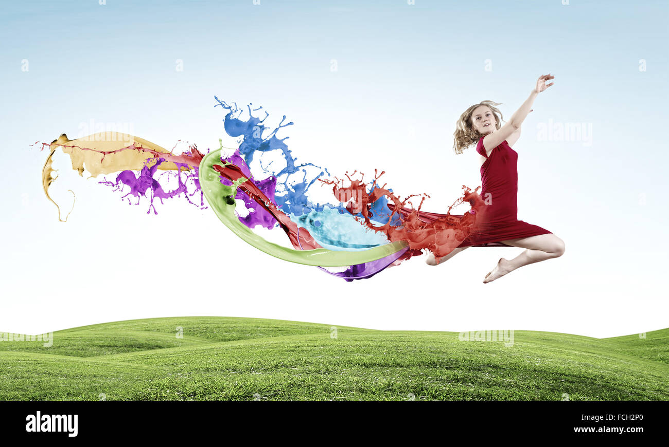 Young woman dancer in red dress jumping high Stock Photo - Alamy