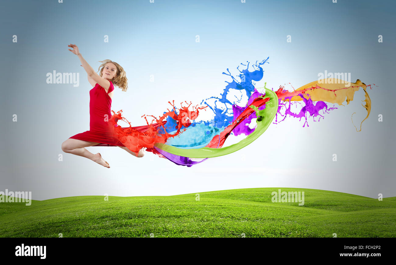 Young woman dancer in red dress jumping high Stock Photo - Alamy