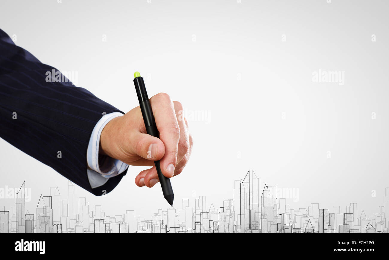 Close up of human hand drawing construction project Stock Photo - Alamy