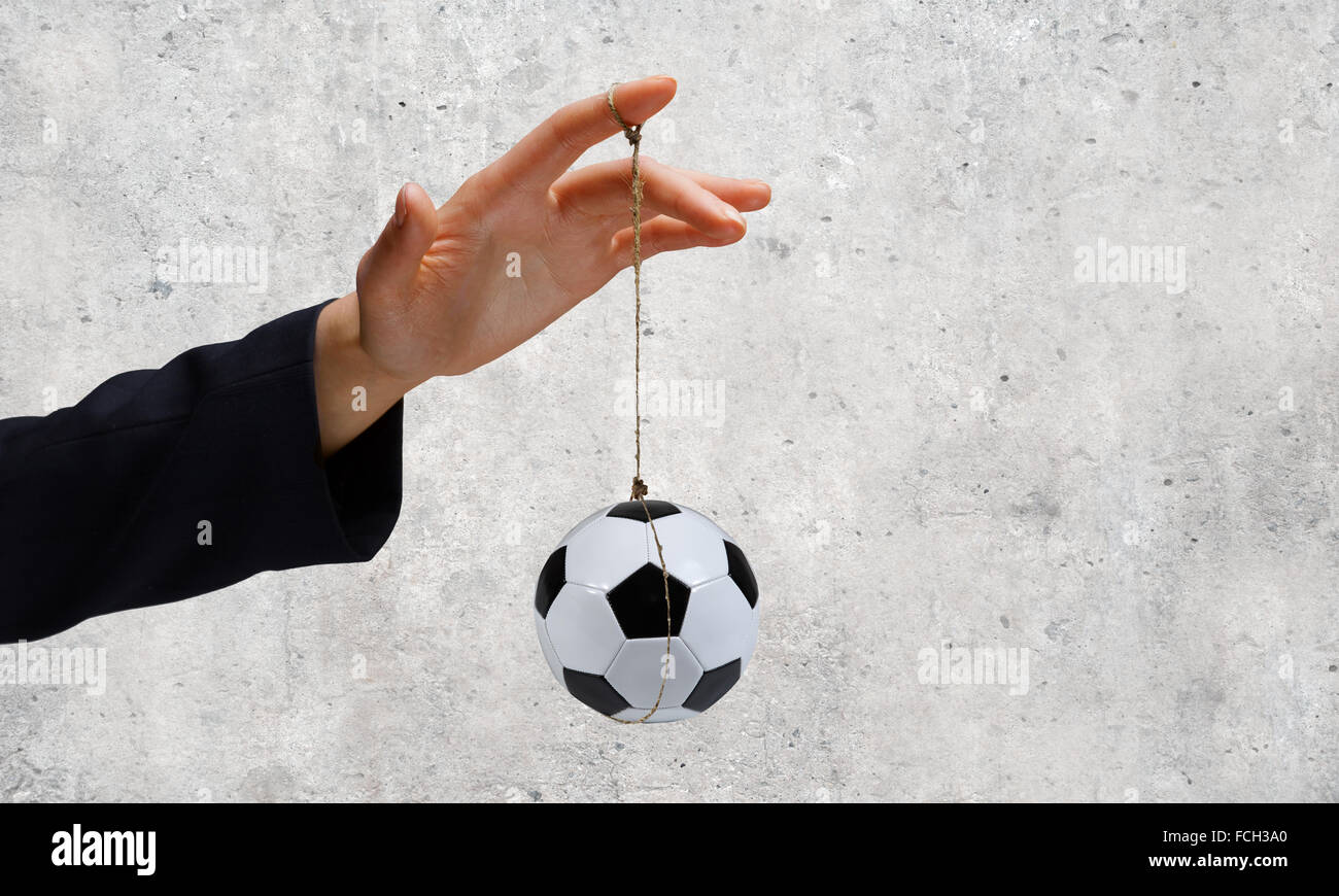 Close up of businessman hand and ball hanging on rope Stock Photo - Alamy