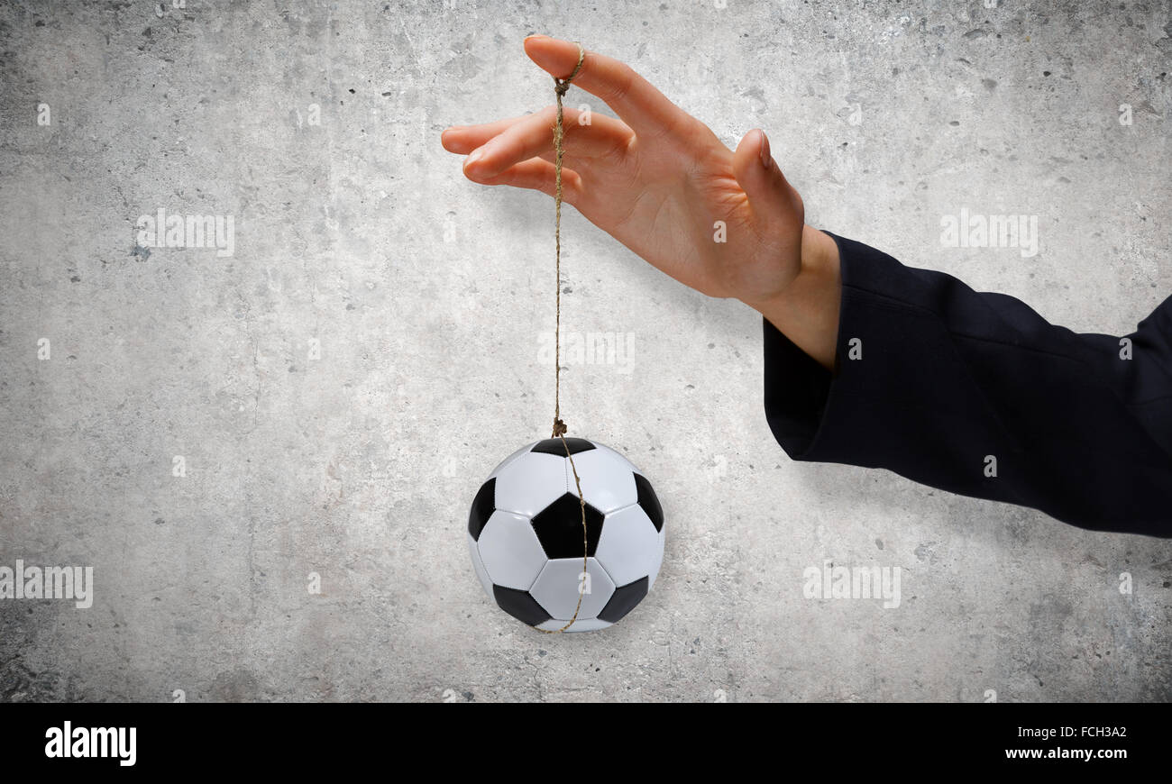 Close up of businessman hand and ball hanging on rope Stock Photo - Alamy