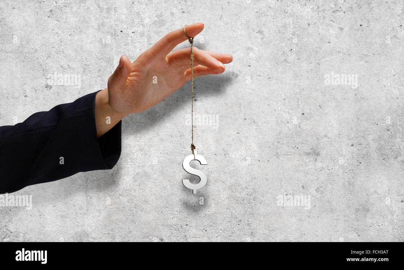 Close up of businessman hand and dollar sign hanging on finger Stock ...