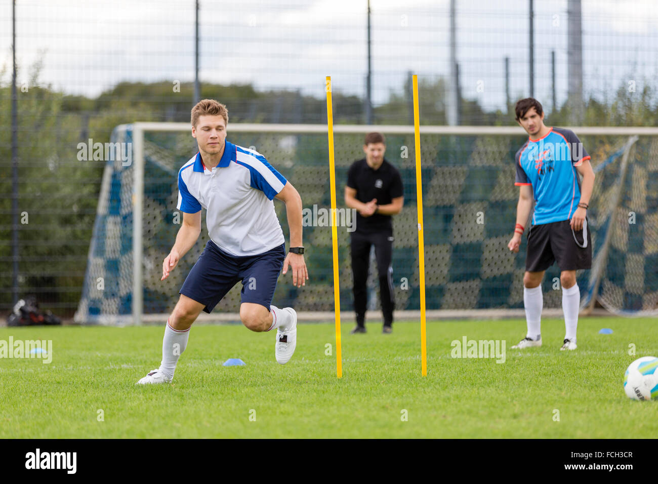 Soccer player exercising on sports field Stock Photo - Alamy