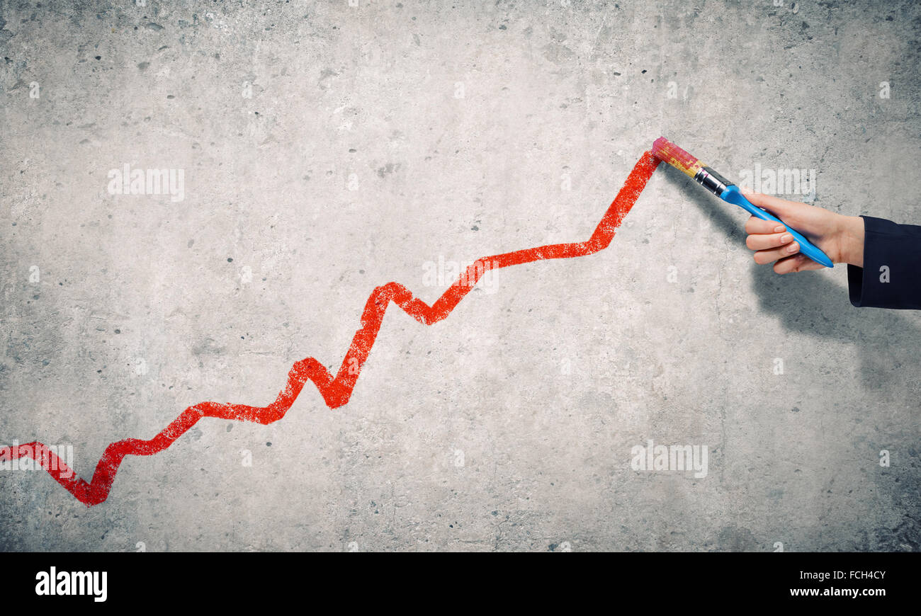 Close up of business person hand drawing graph on wall Stock Photo - Alamy
