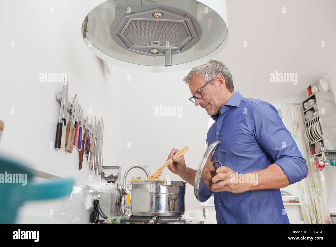 Mature man cooking in kitchen Stock Photo - Alamy
