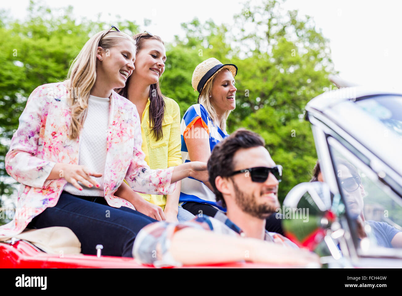 Happy friends in a convertible Stock Photo - Alamy