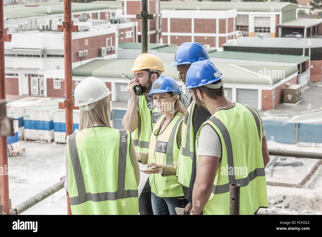 Construction workers and architects talking on construction site Stock ...