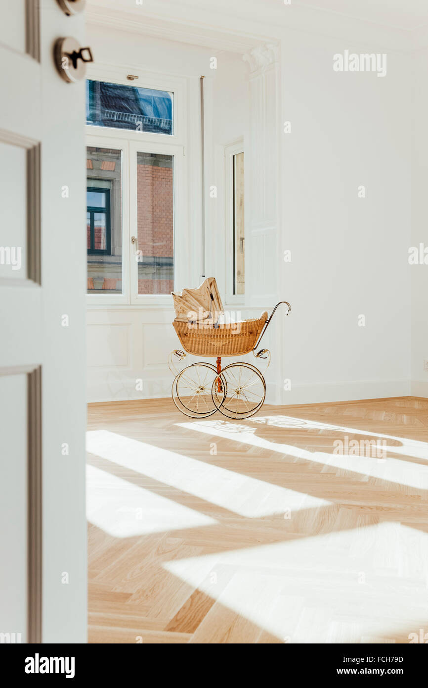 Pram in empty room open doors Stock Photo - Alamy