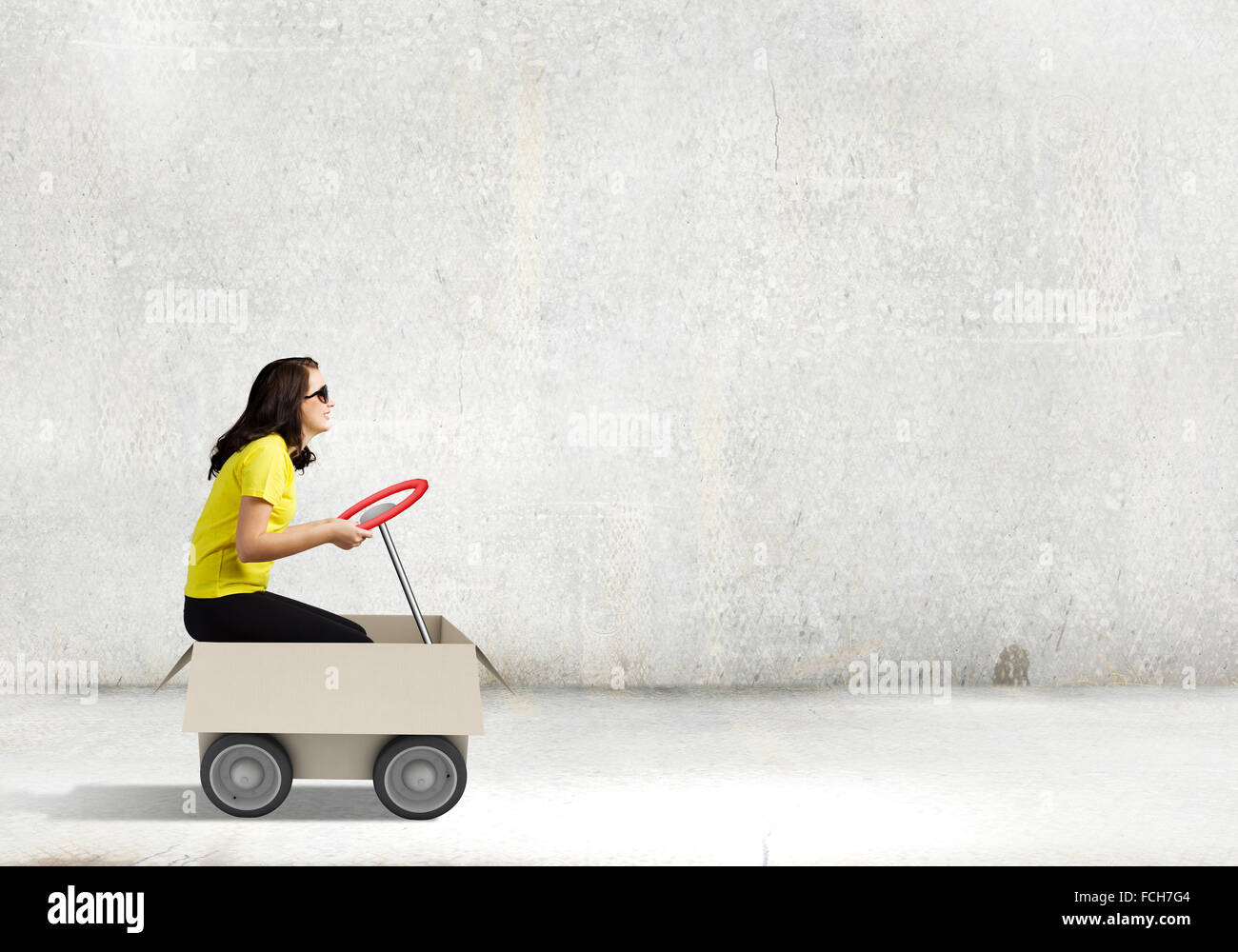 Young funny woman riding in carton box Stock Photo - Alamy
