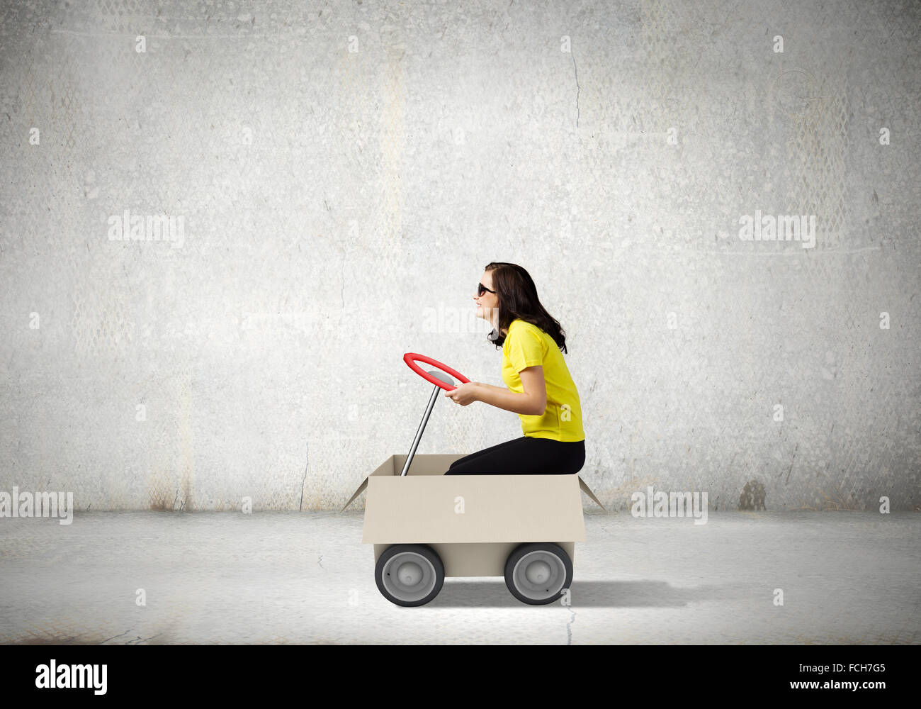 Young funny woman riding in carton box Stock Photo - Alamy