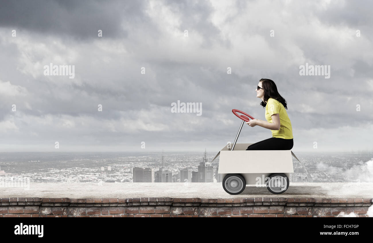 Young funny woman riding in carton box Stock Photo - Alamy