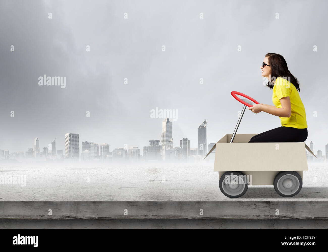 Young funny woman riding in carton box Stock Photo - Alamy