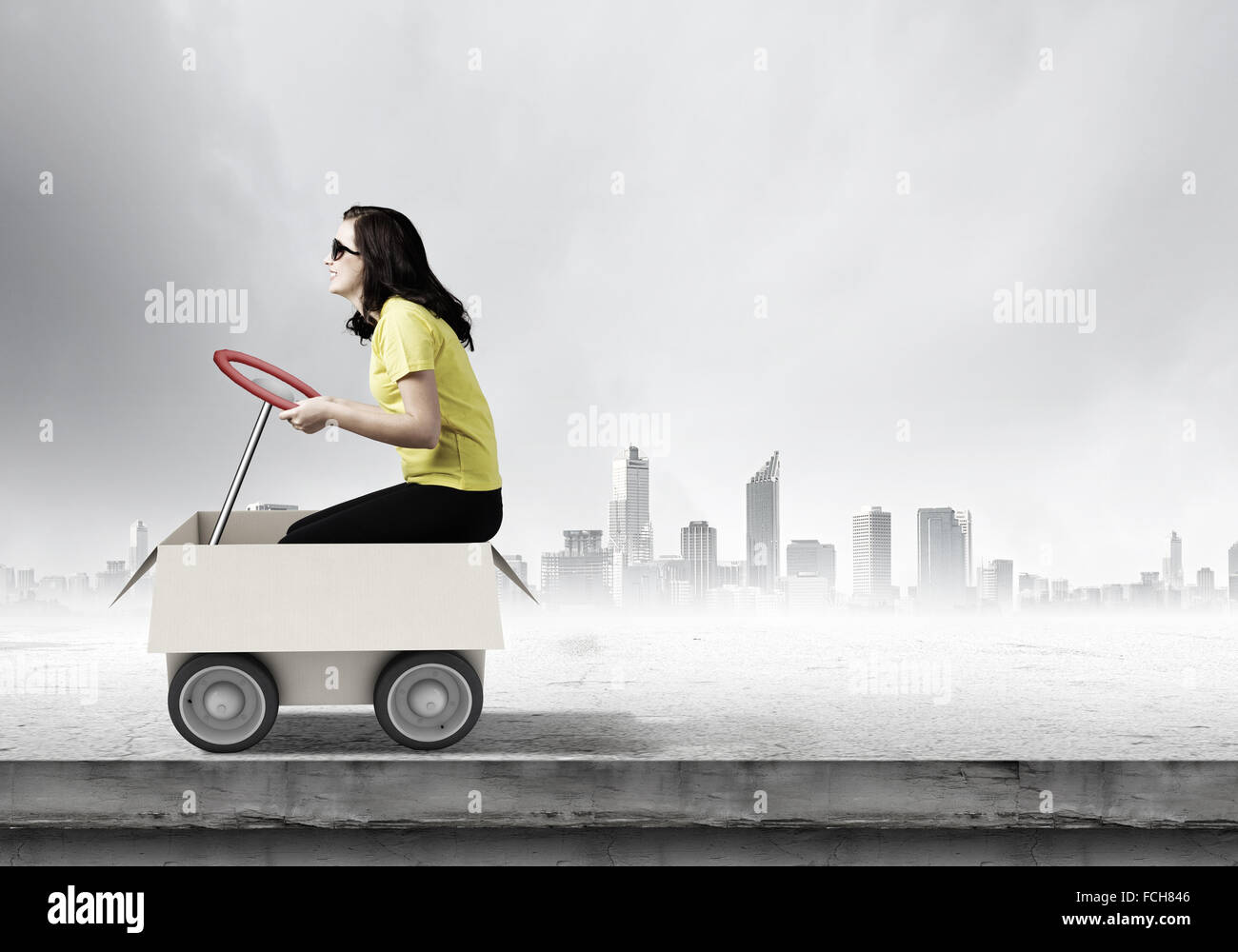 Young funny woman riding in carton box Stock Photo - Alamy