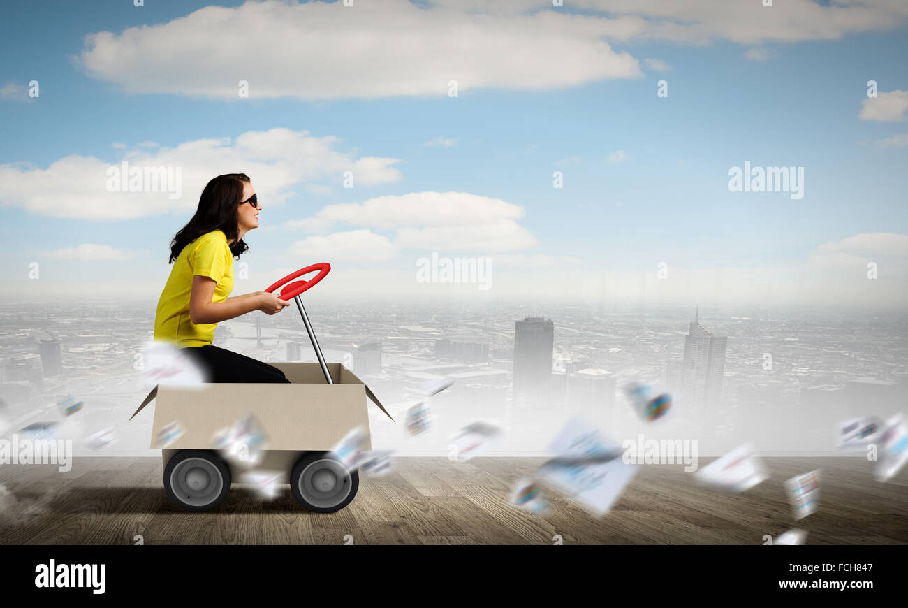 Young funny woman riding in carton box Stock Photo - Alamy