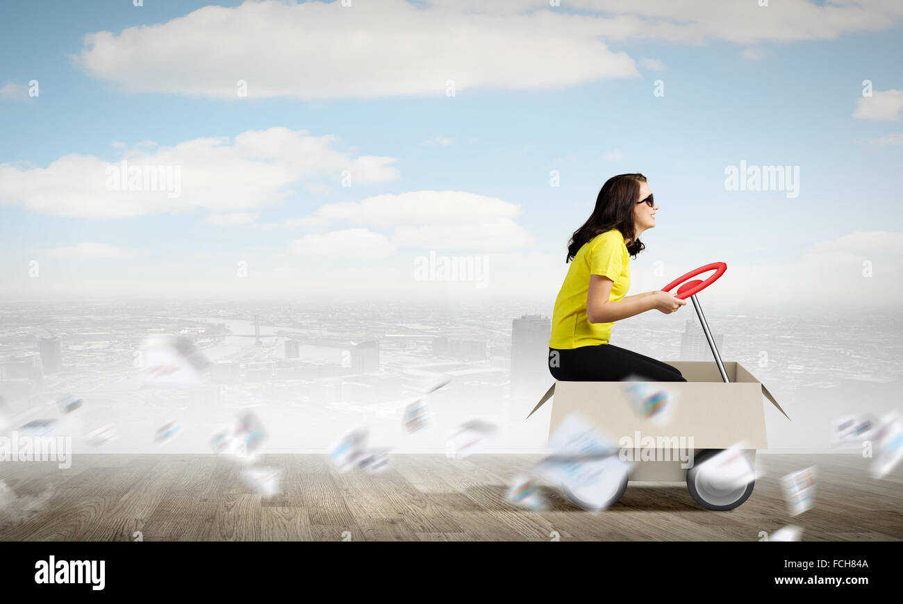 Young funny woman riding in carton box Stock Photo - Alamy