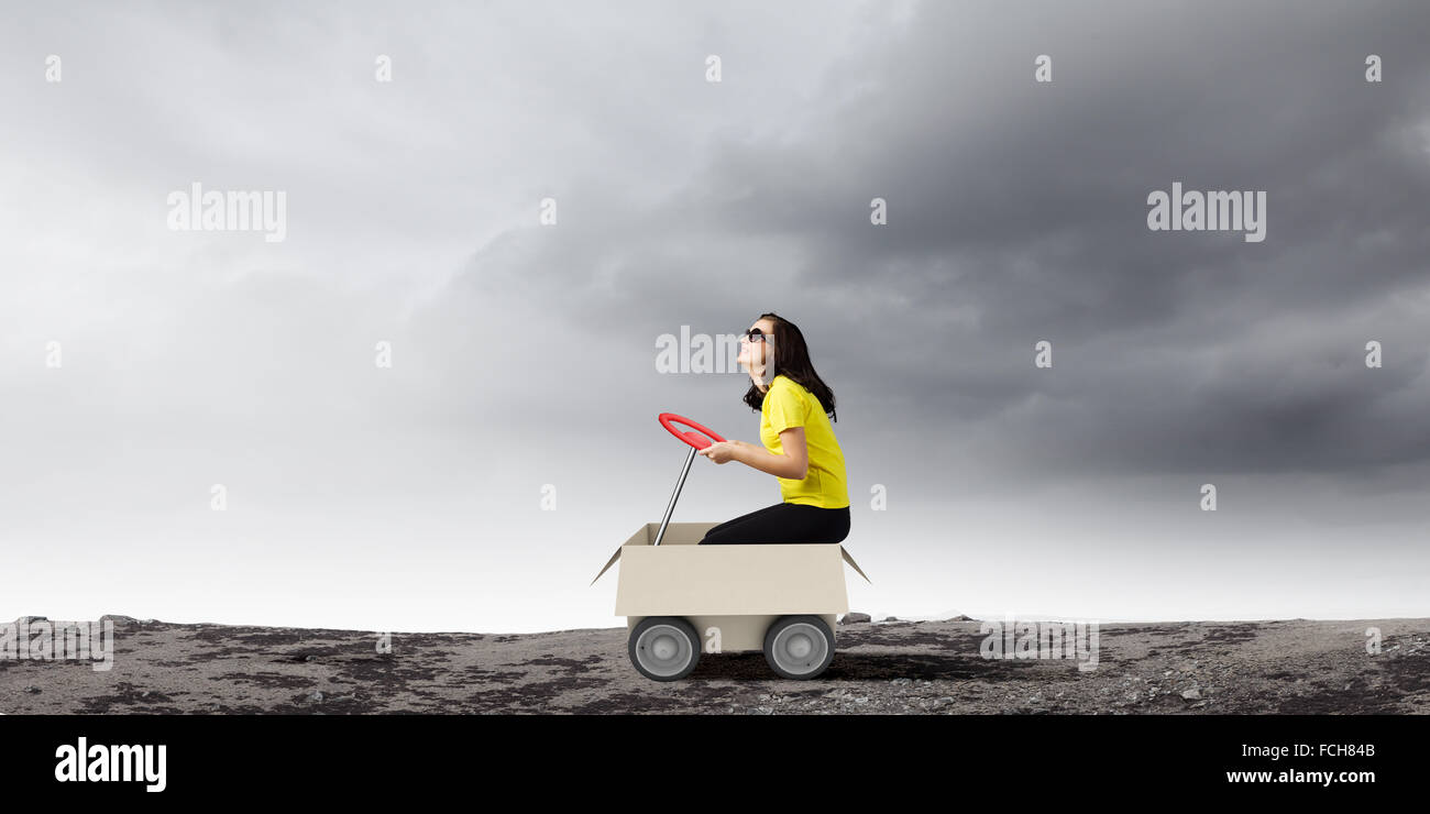 Young funny woman riding in carton box Stock Photo - Alamy