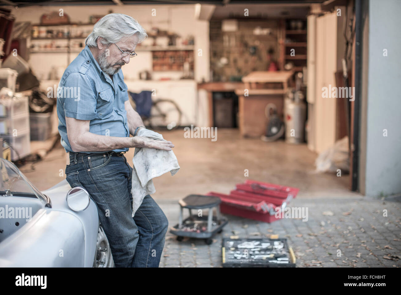 Senior man restoring a car Stock Photo - Alamy
